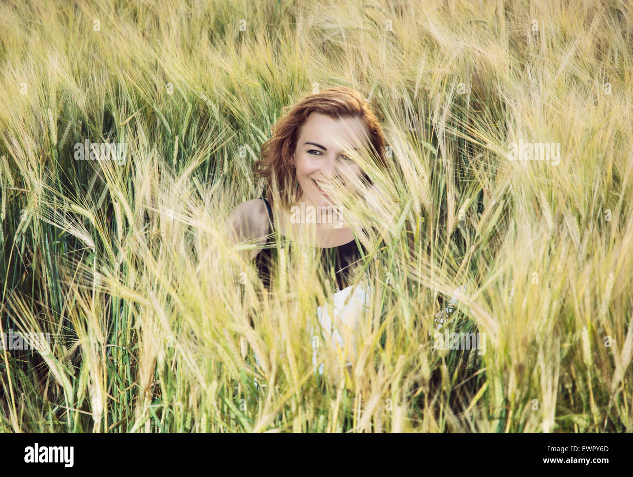 Young crazy woman in the wheat field. Beauty and nature Stock Photo - Alamy