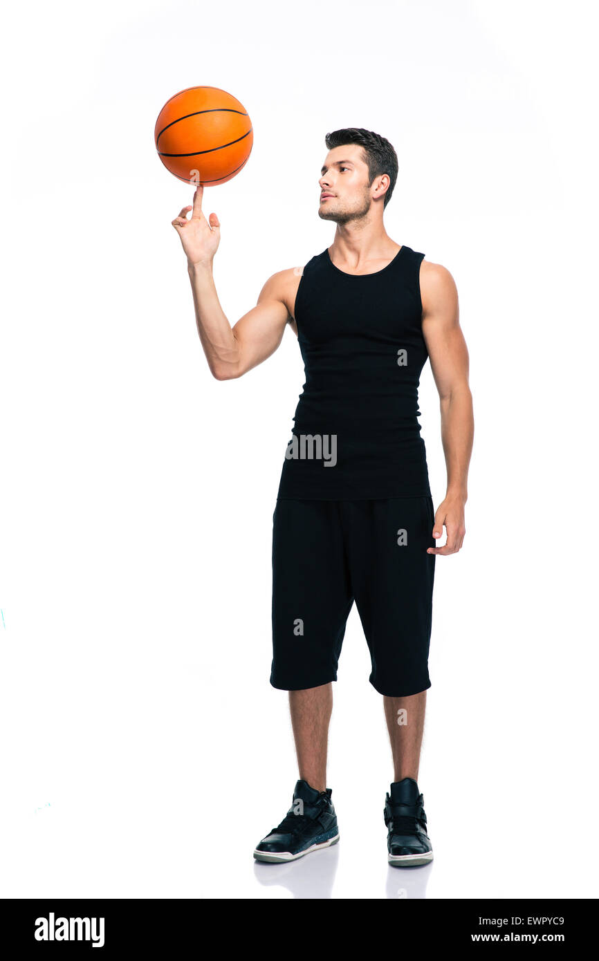 Full length portrait of a handsome basketball player spinning ball on ...