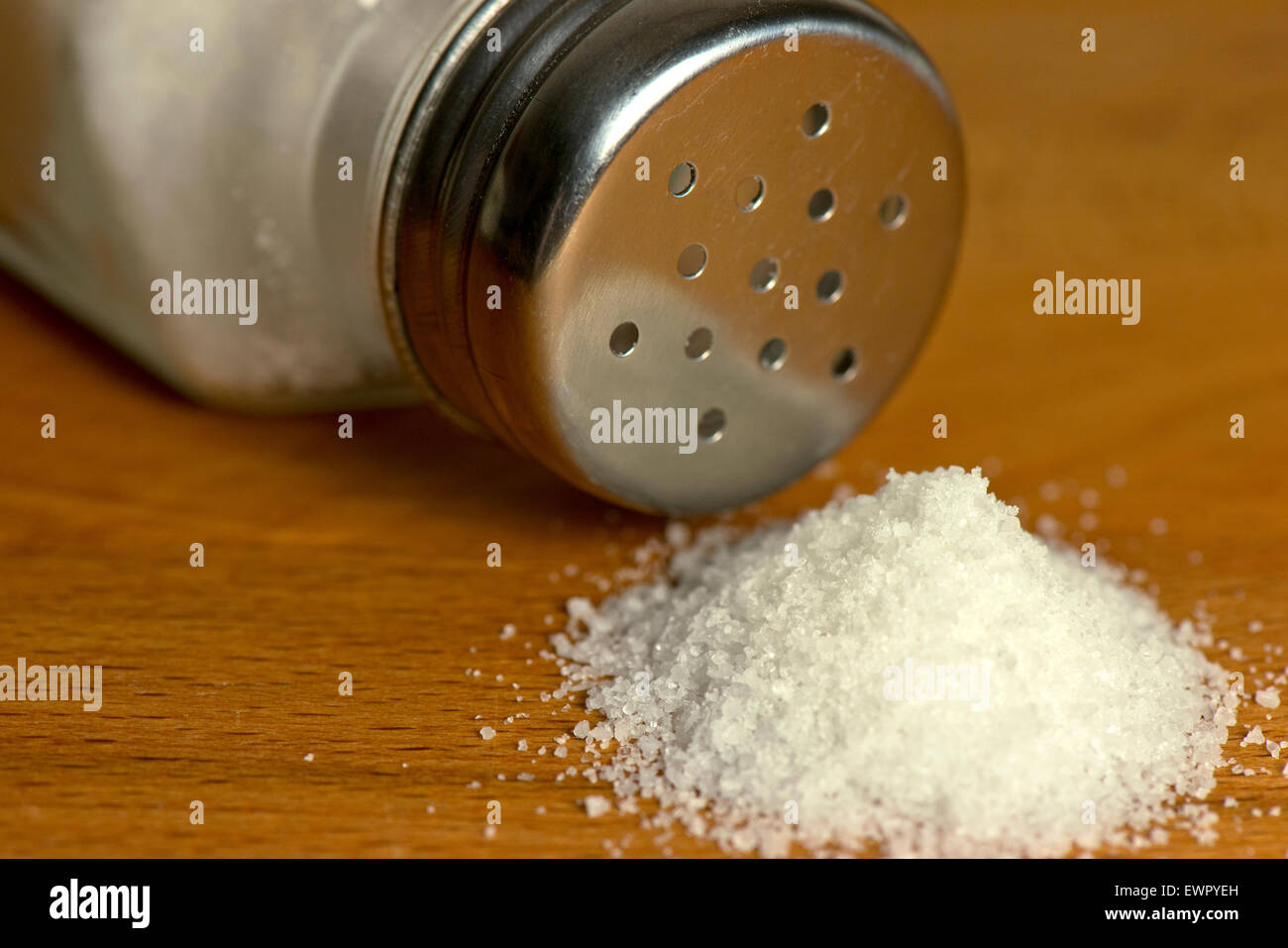 Salt spilling on table from salt cellar Stock Photo - Alamy