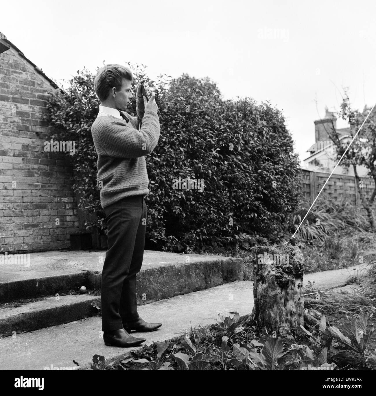 23 year old Gordon Faulkner in his garden, holding the camera with ...