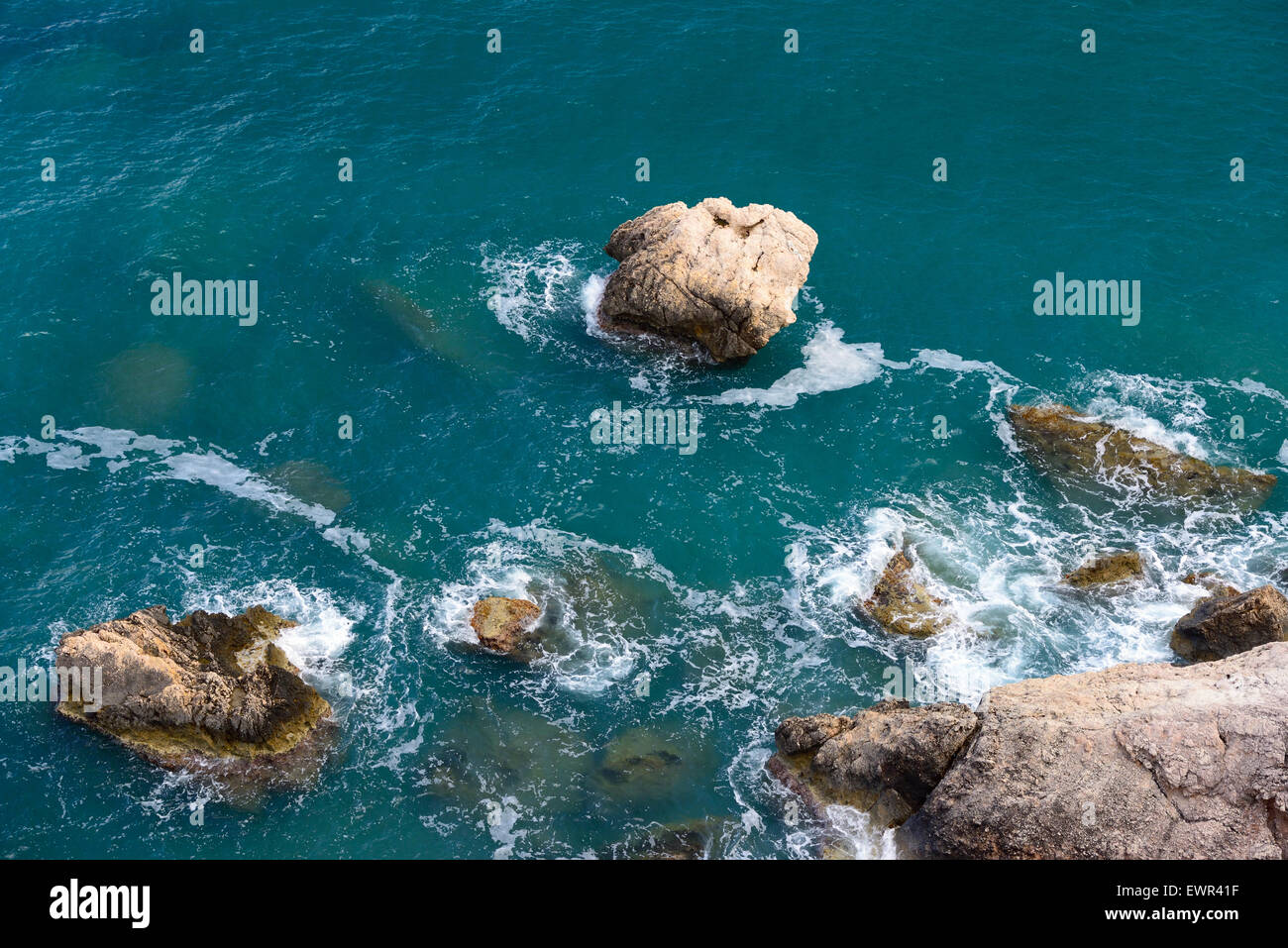 rocks in the blue sea Stock Photo - Alamy