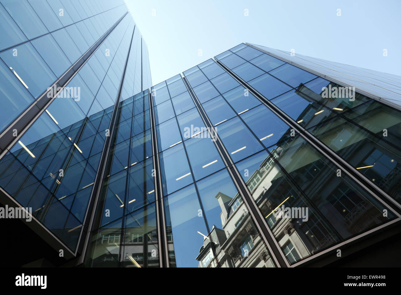 Wide-angle view looking up at a modern glass and steel, high-rise ...