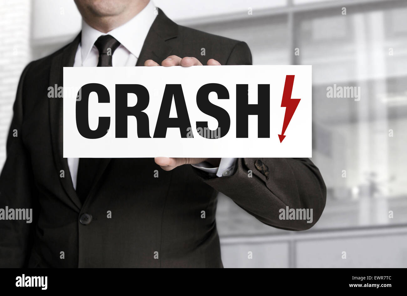 Crash sign is held by businessman Stock Photo - Alamy