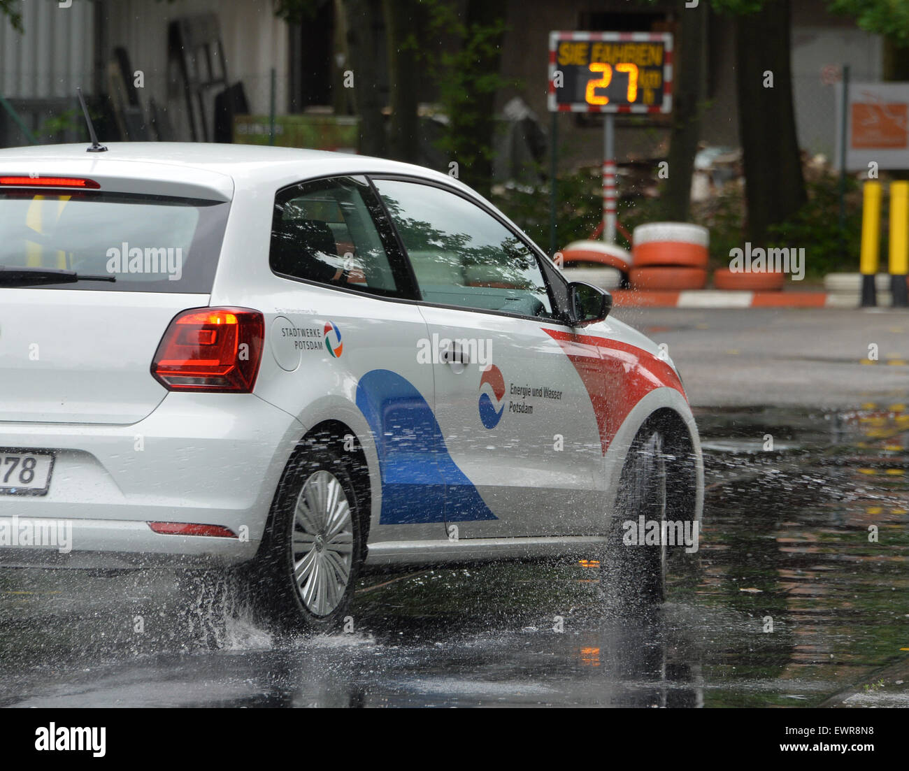 A car brakes and moves on a water surface during a road safety training ...