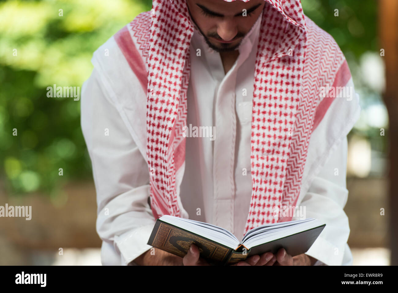Young Muslim Man Making Traditional Prayer To God While Wearing A ...