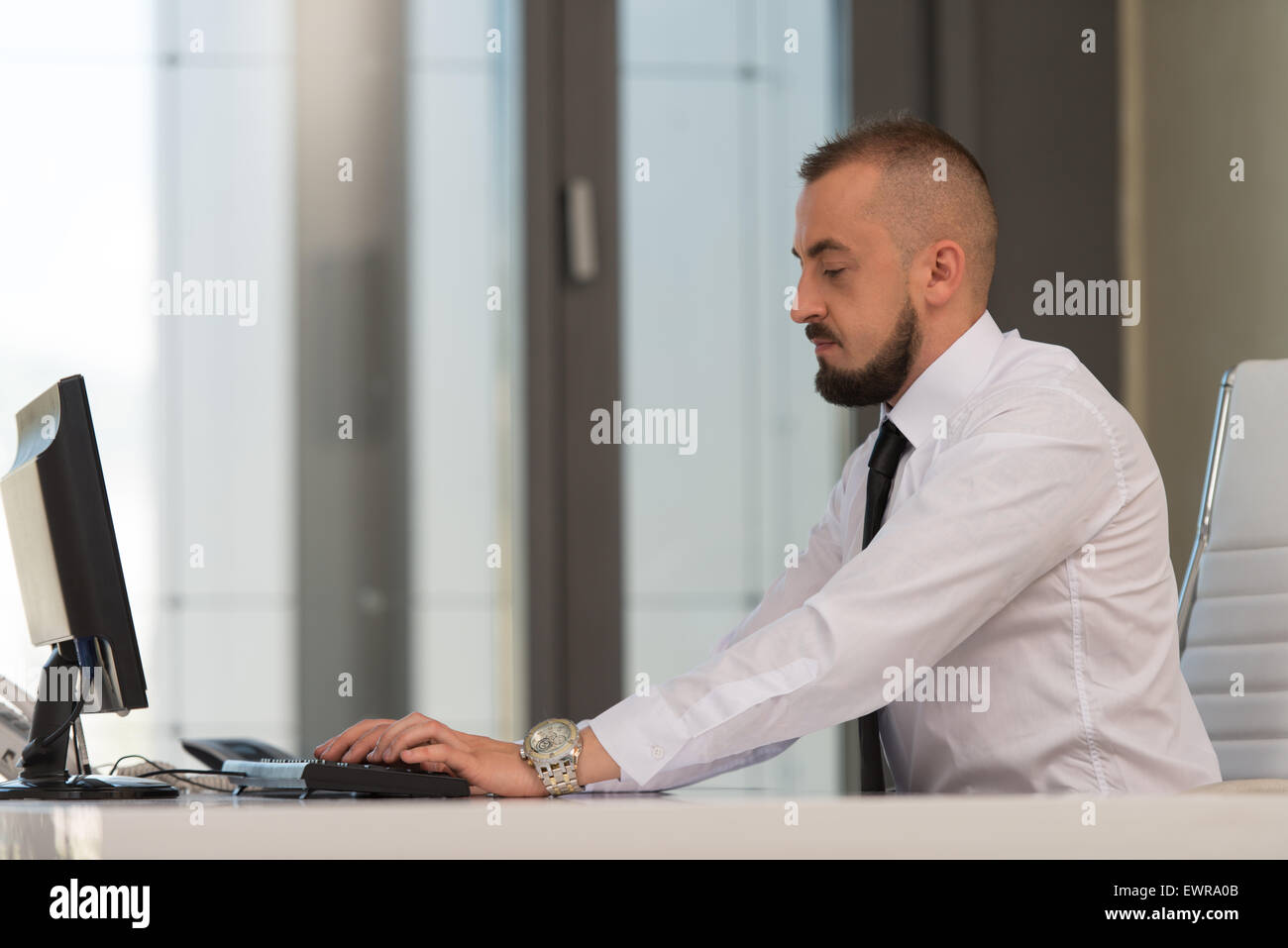 Portrait Of A Young Business Man Using A Computer In The Office Stock ...