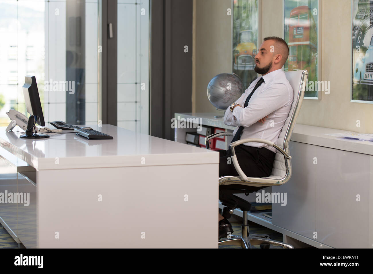 Portrait Of A Young Business Man Using A Computer In The Office Stock ...