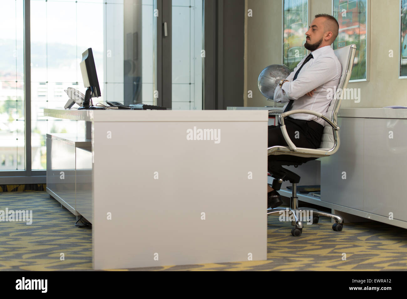 Portrait Of A Young Business Man Using A Computer In The Office Stock ...