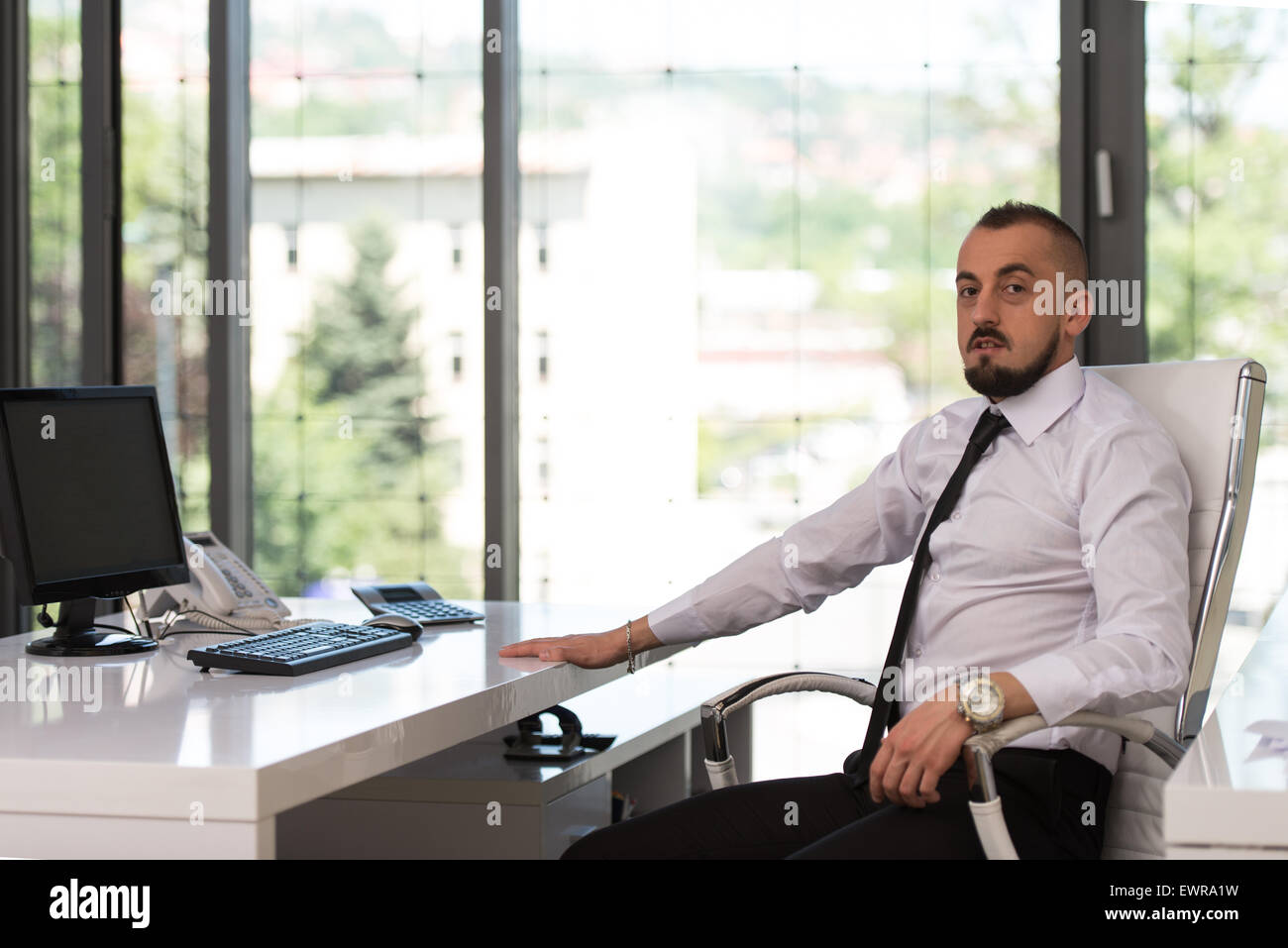 Portrait Of A Young Business Man Using A Computer In The Office Stock ...