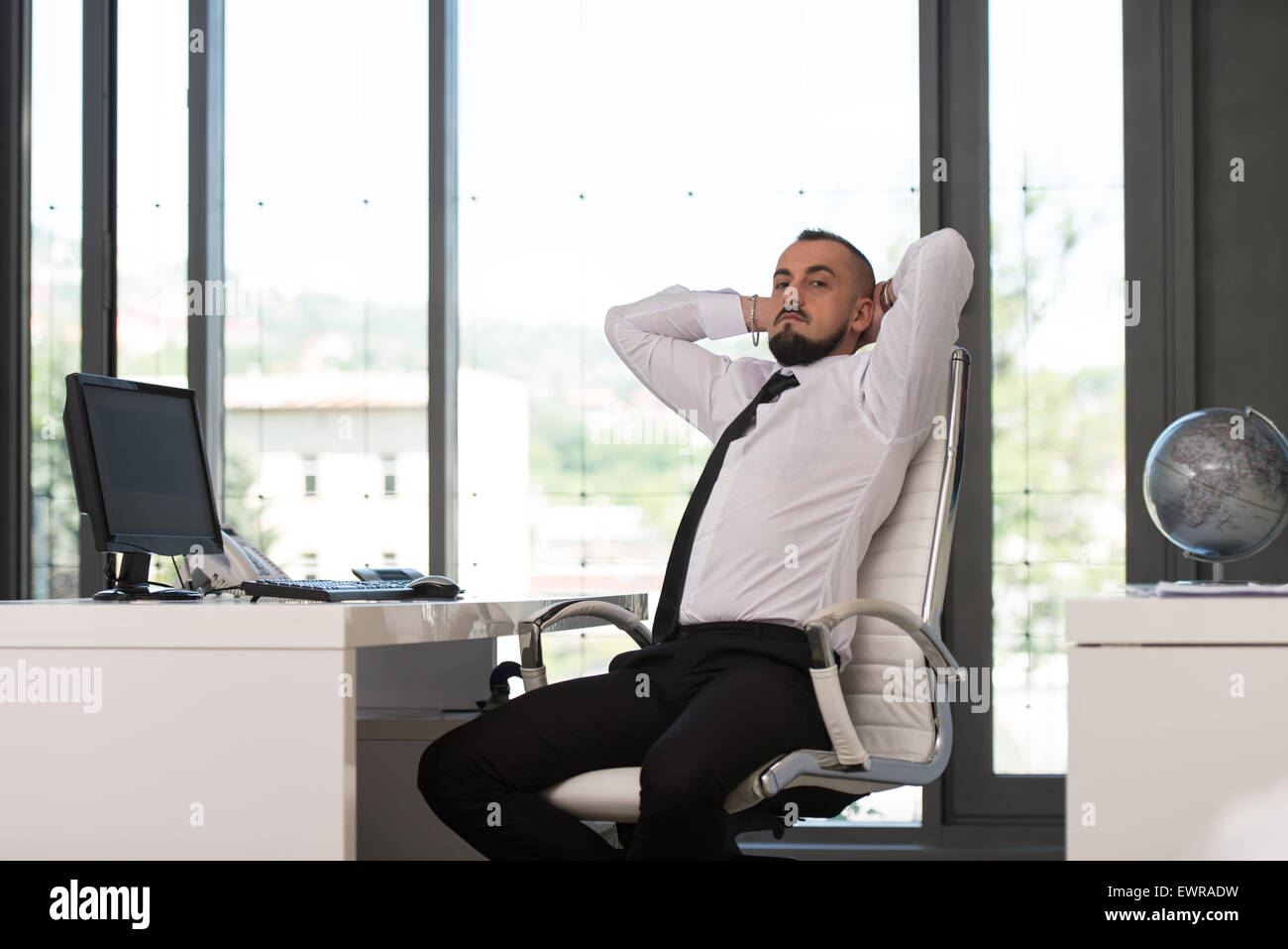 Portrait Of A Young Business Man Using A Computer In The Office Stock ...