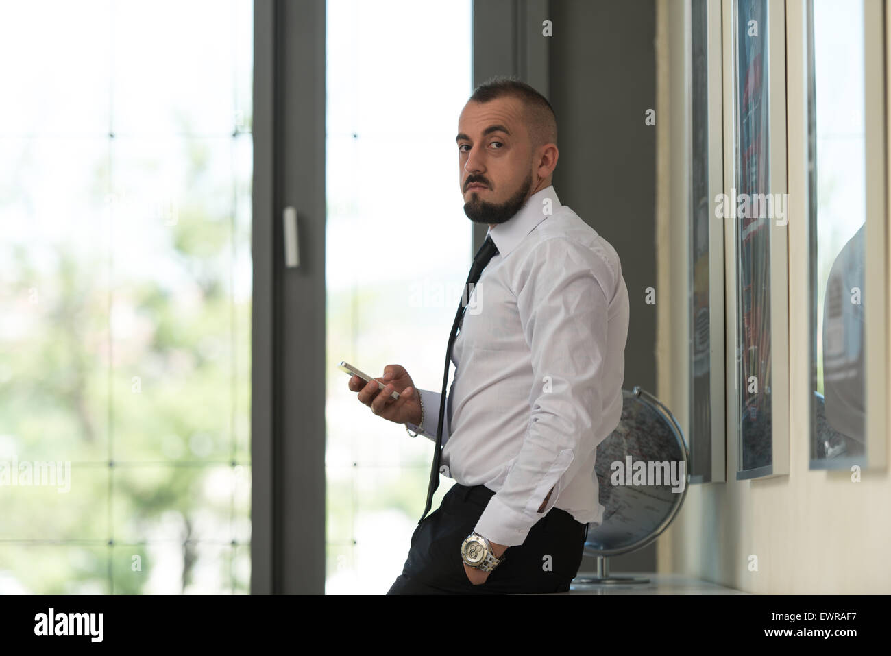 Business Man Reading Text Message On A Mobile In A Modern Office Stock ...