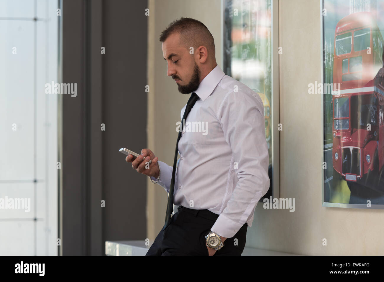 Business Man Reading Text Message On A Mobile In A Modern Office Stock ...