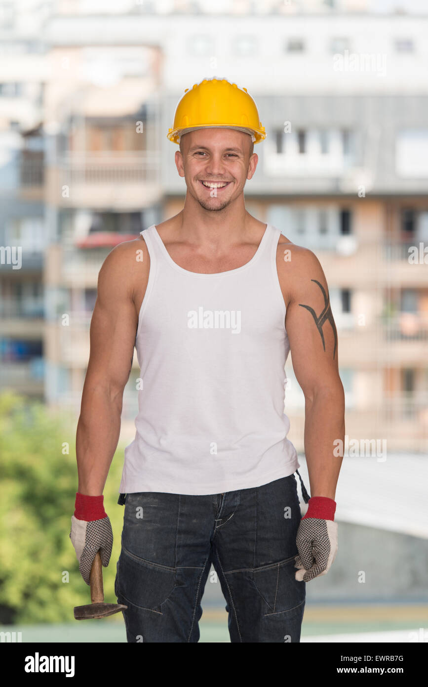 Handsome Construction Man Using A Hammer Stock Photo - Alamy