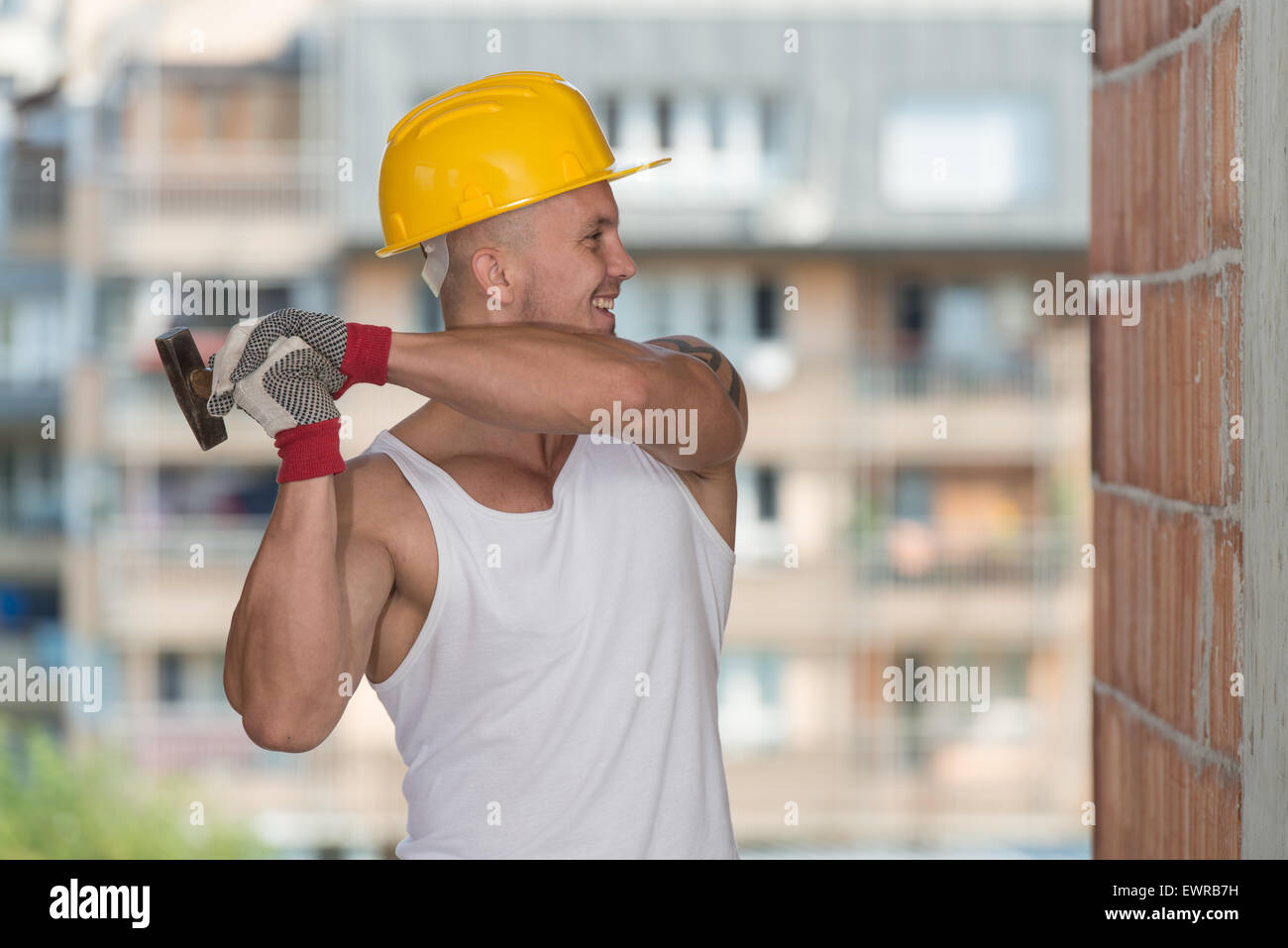 A Handsome Construction Man Using A Hammer To Nail Together Wood Stock ...