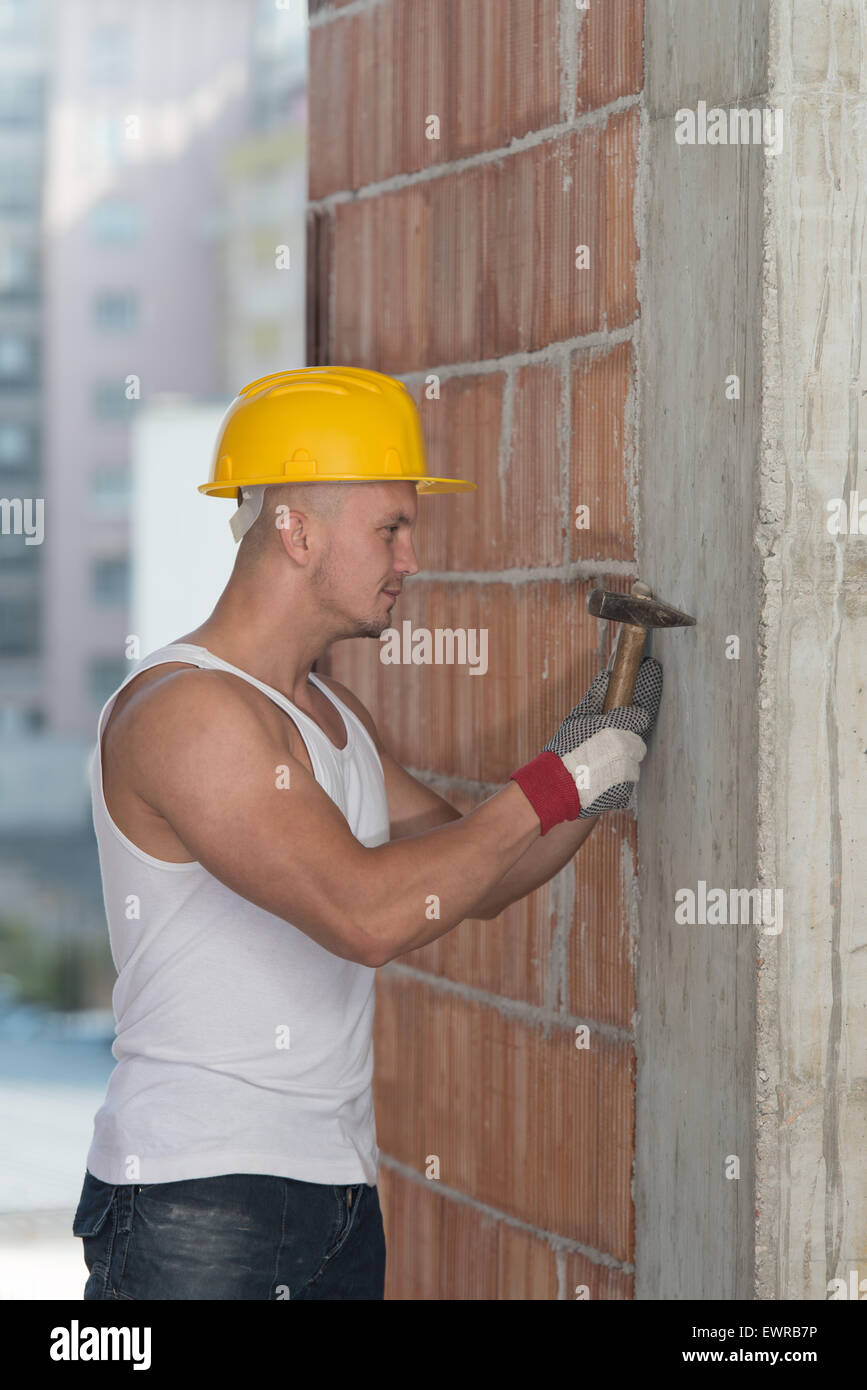A Handsome Construction Man Using A Hammer To Nail Together Wood Stock ...