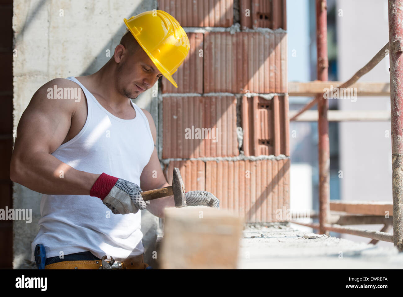 A Handsome Construction Man Using A Hammer To Nail Together Wood Stock ...