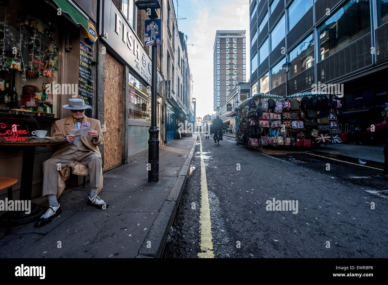 A very sharply dressed man (Soho George) reads in a Soho cafe in ...