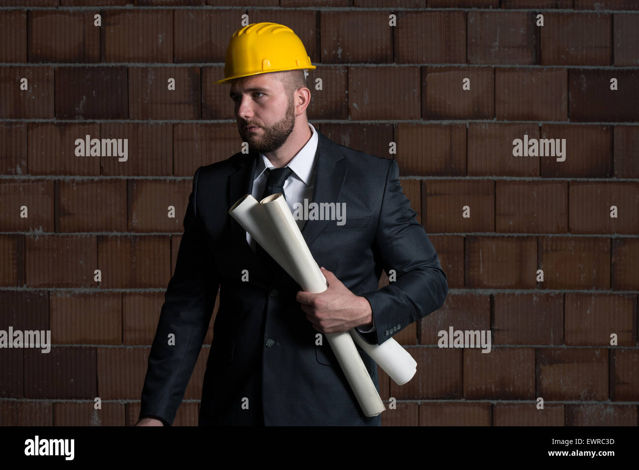 Portrait Of Construction Master With Yellow Helmet And Blueprint In ...