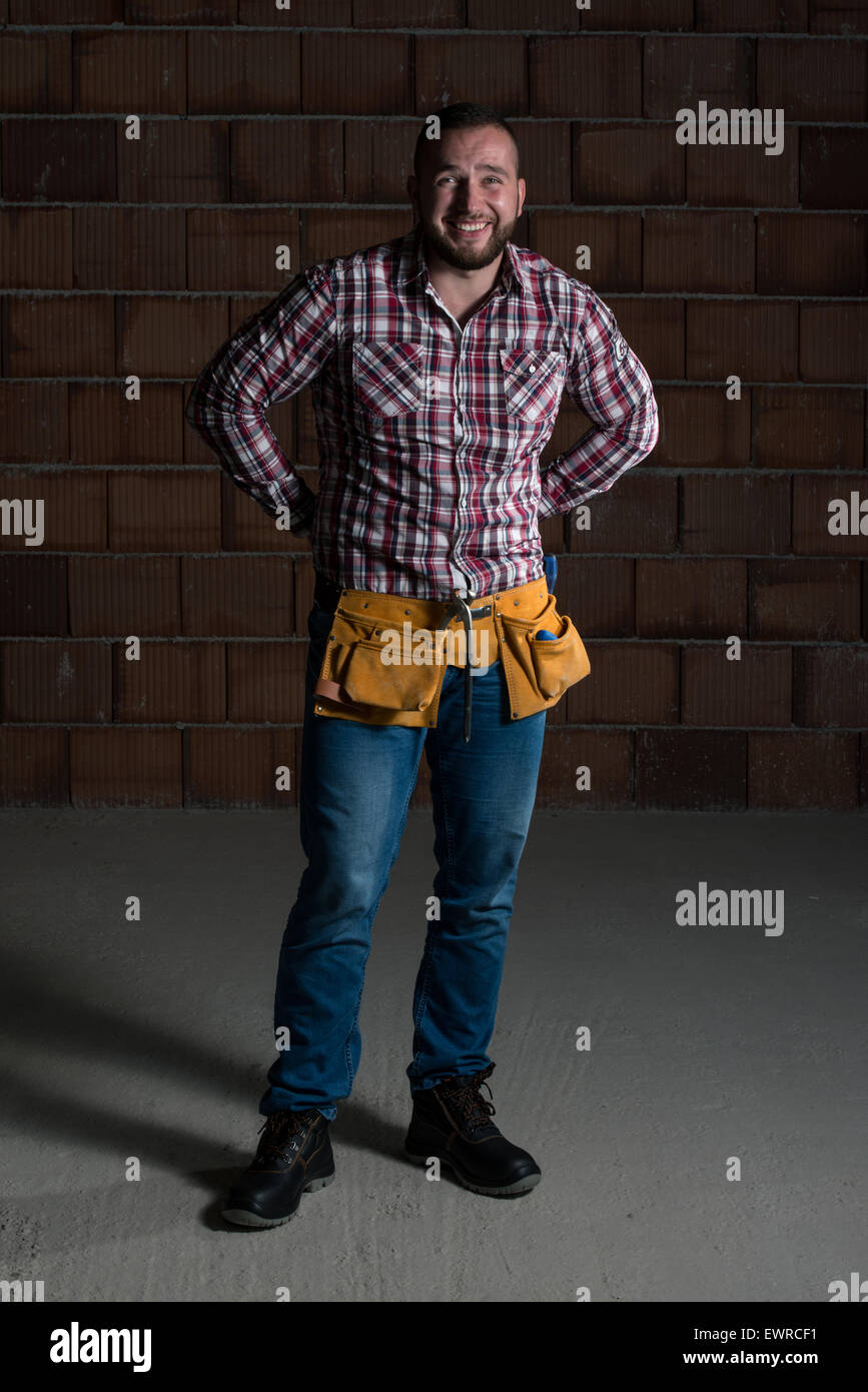 Portrait Of Handsome Builder With Tools Stock Photo - Alamy
