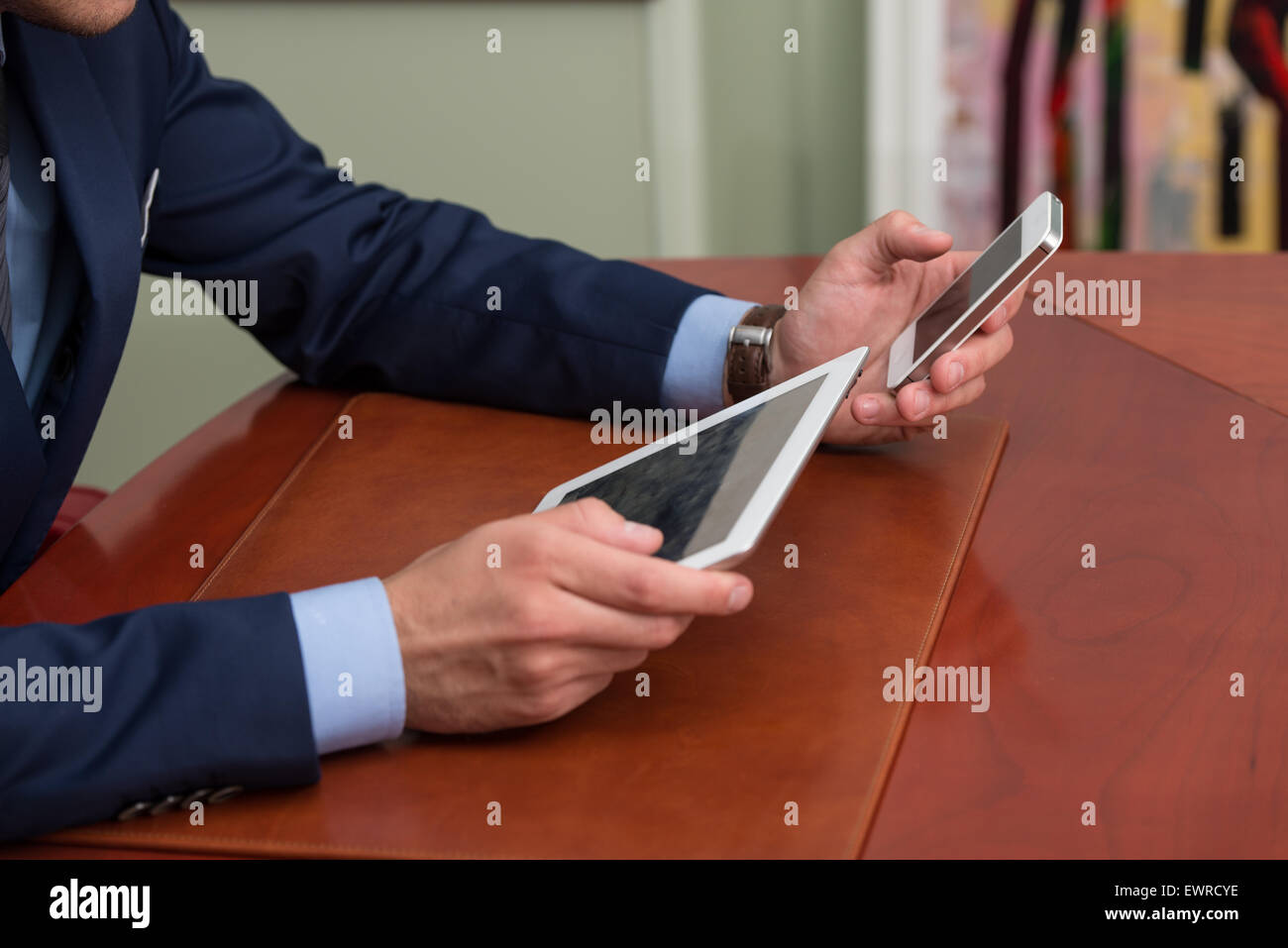 Young Businessmen Using Touchpad At Meeting Stock Photo - Alamy