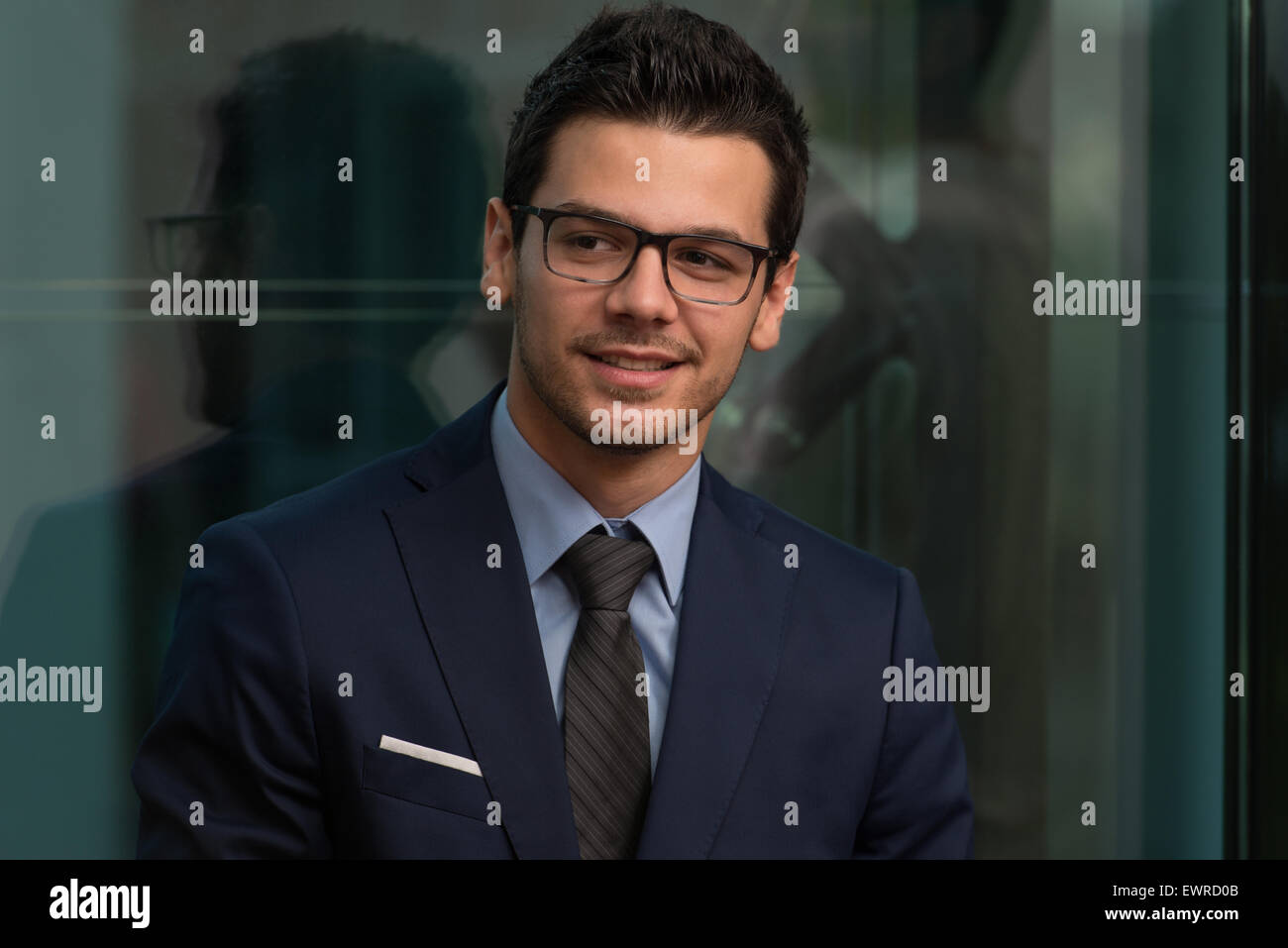 Portrait Of Handsome Confident Young Businessman Standing Arms Crossed Stock Photo - Alamy
