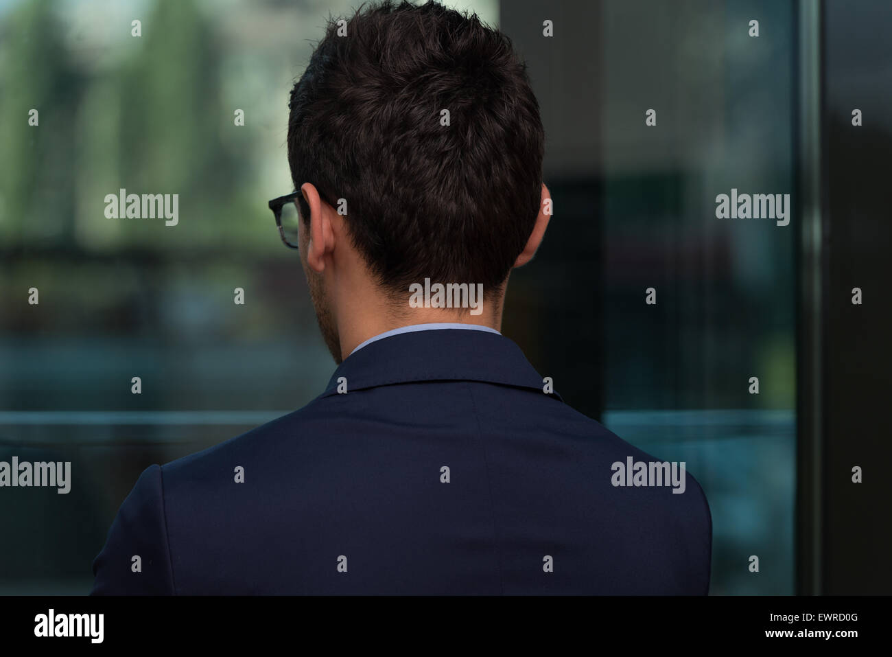 Rear View Of Young Businessman In Office Stock Photo - Alamy
