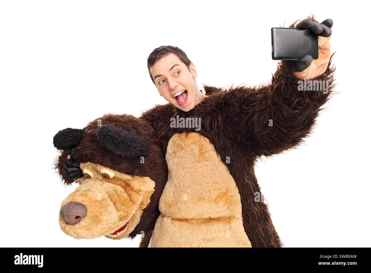 Studio shot of a man in a bear costume taking a selfie with his cell ...
