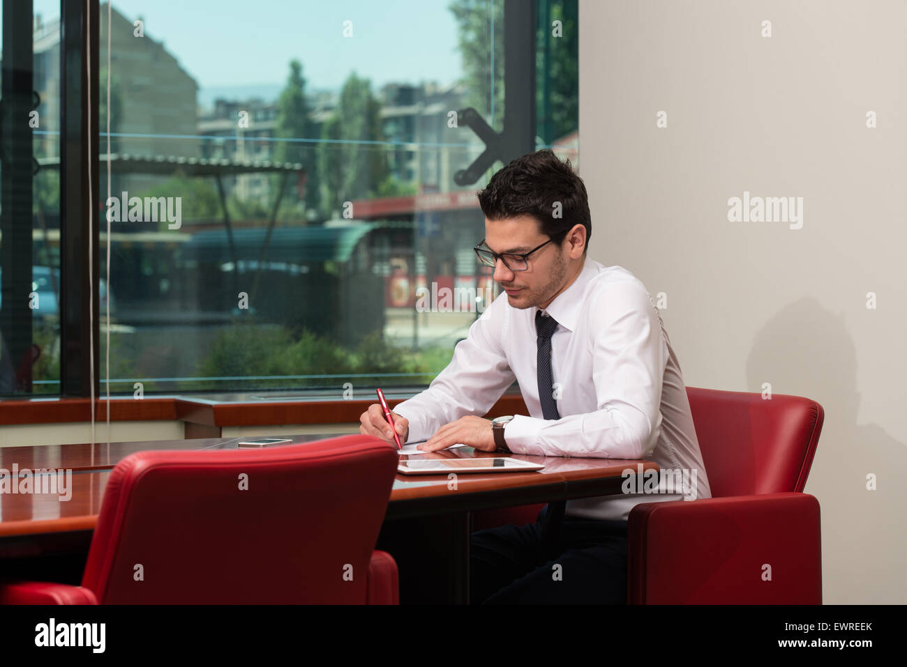 Young businessman thinking writing document hi-res stock photography ...