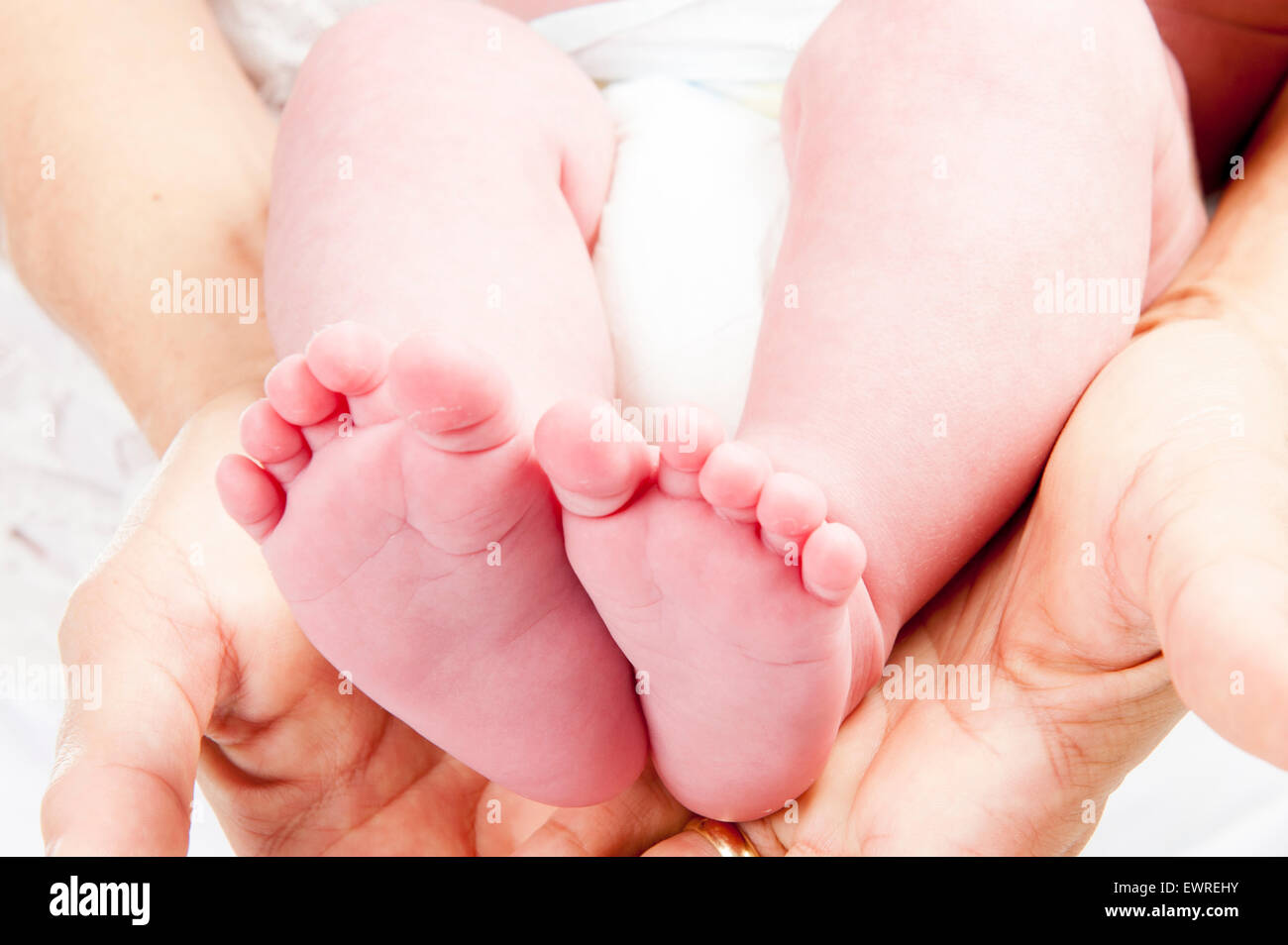 New born feet over white background Stock Photo - Alamy