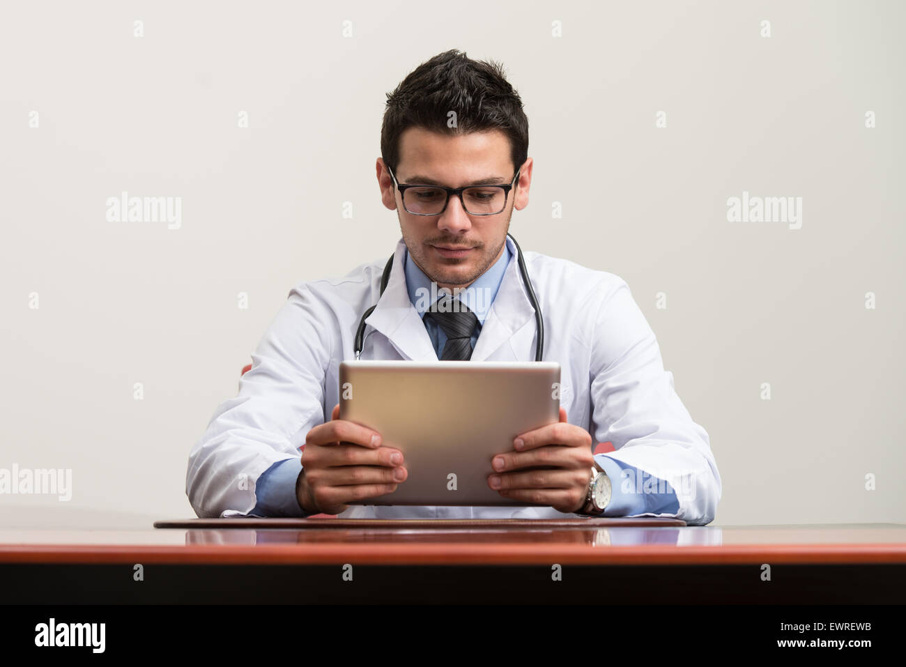 Handsome Doctor Looking At His Computer Monitor In His Office Stock ...
