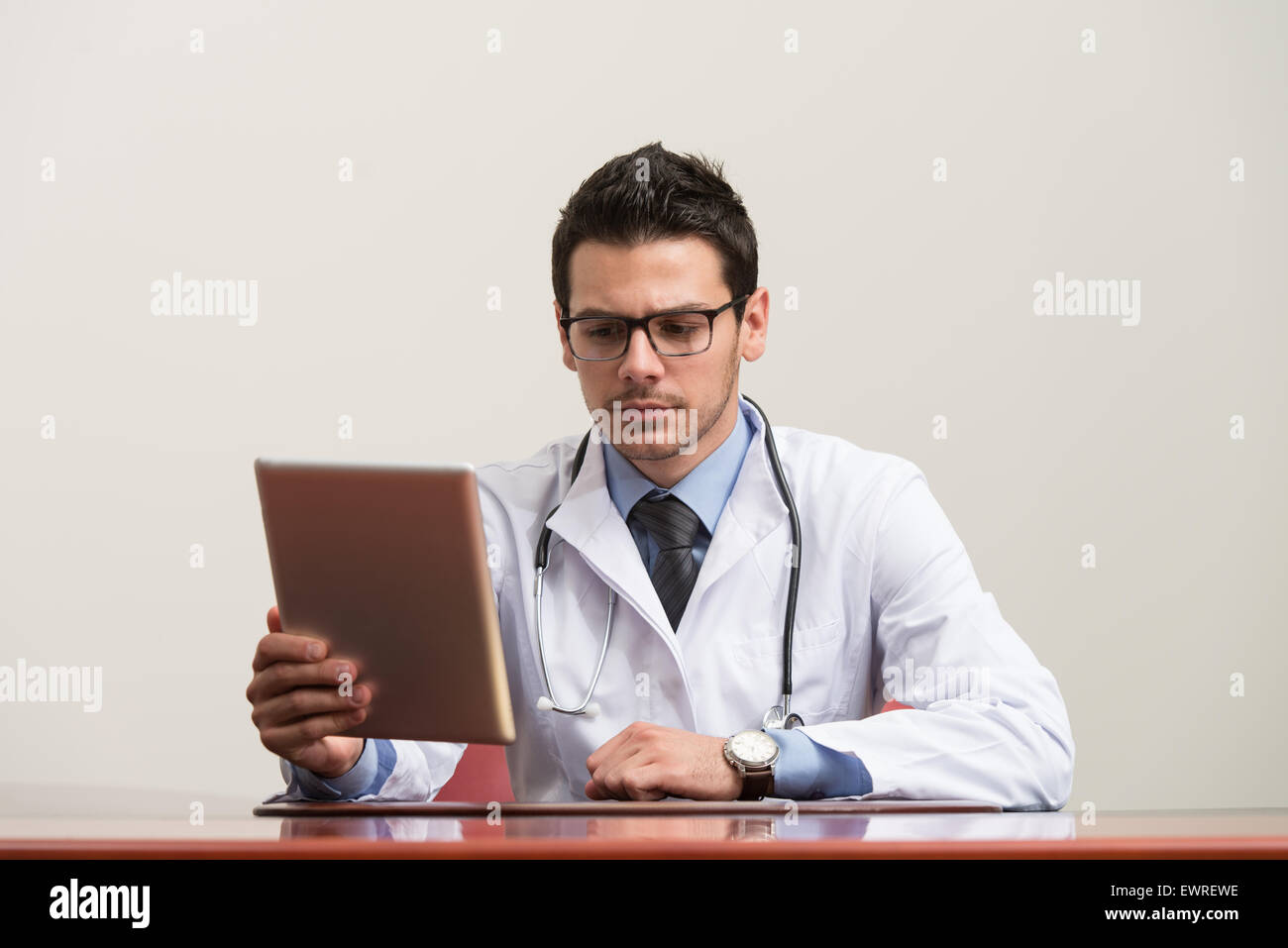 Handsome Doctor Looking At His Computer Monitor In His Office Stock ...