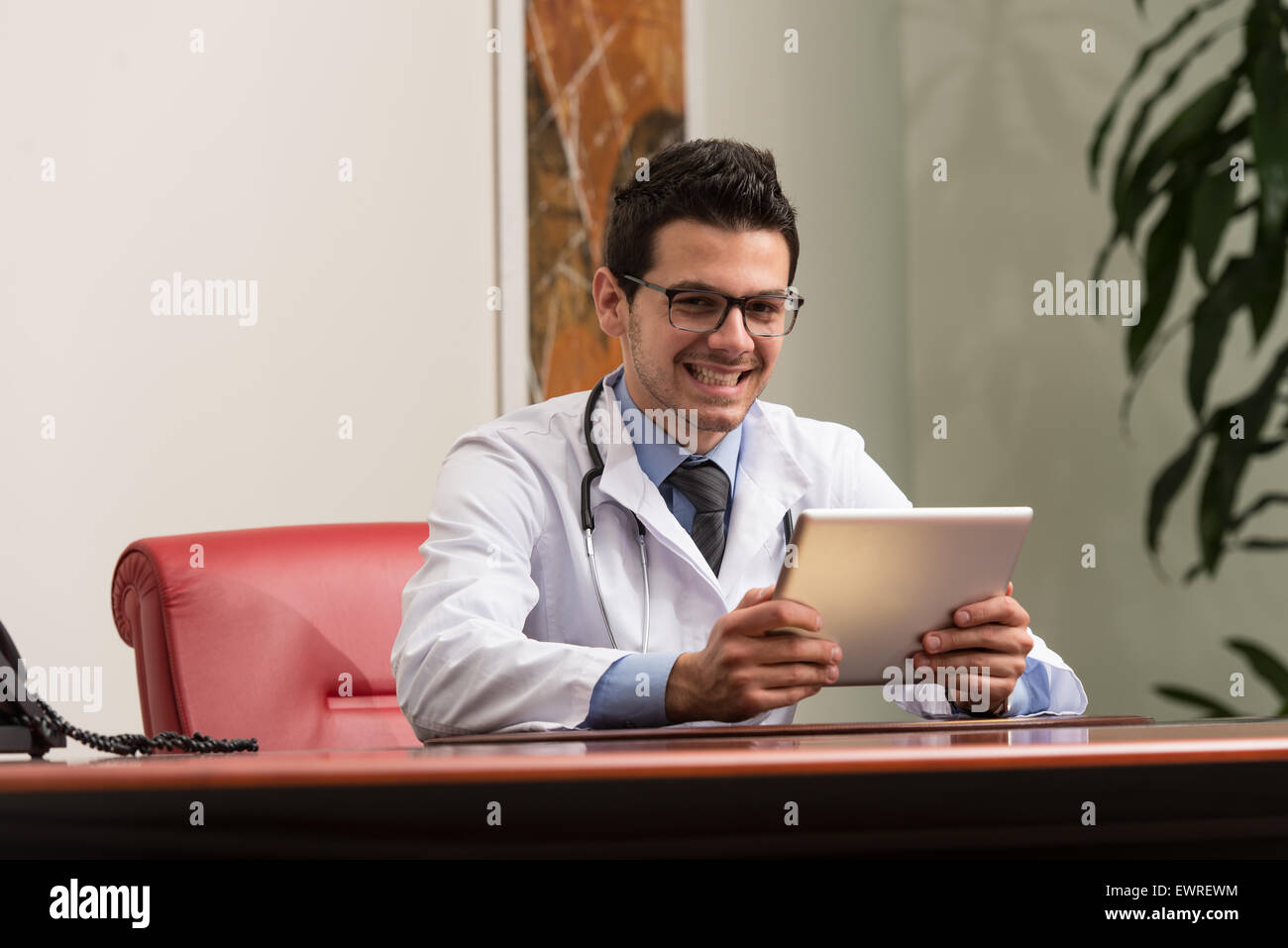 Handsome Doctor Looking At His Computer Monitor In His Office Stock ...