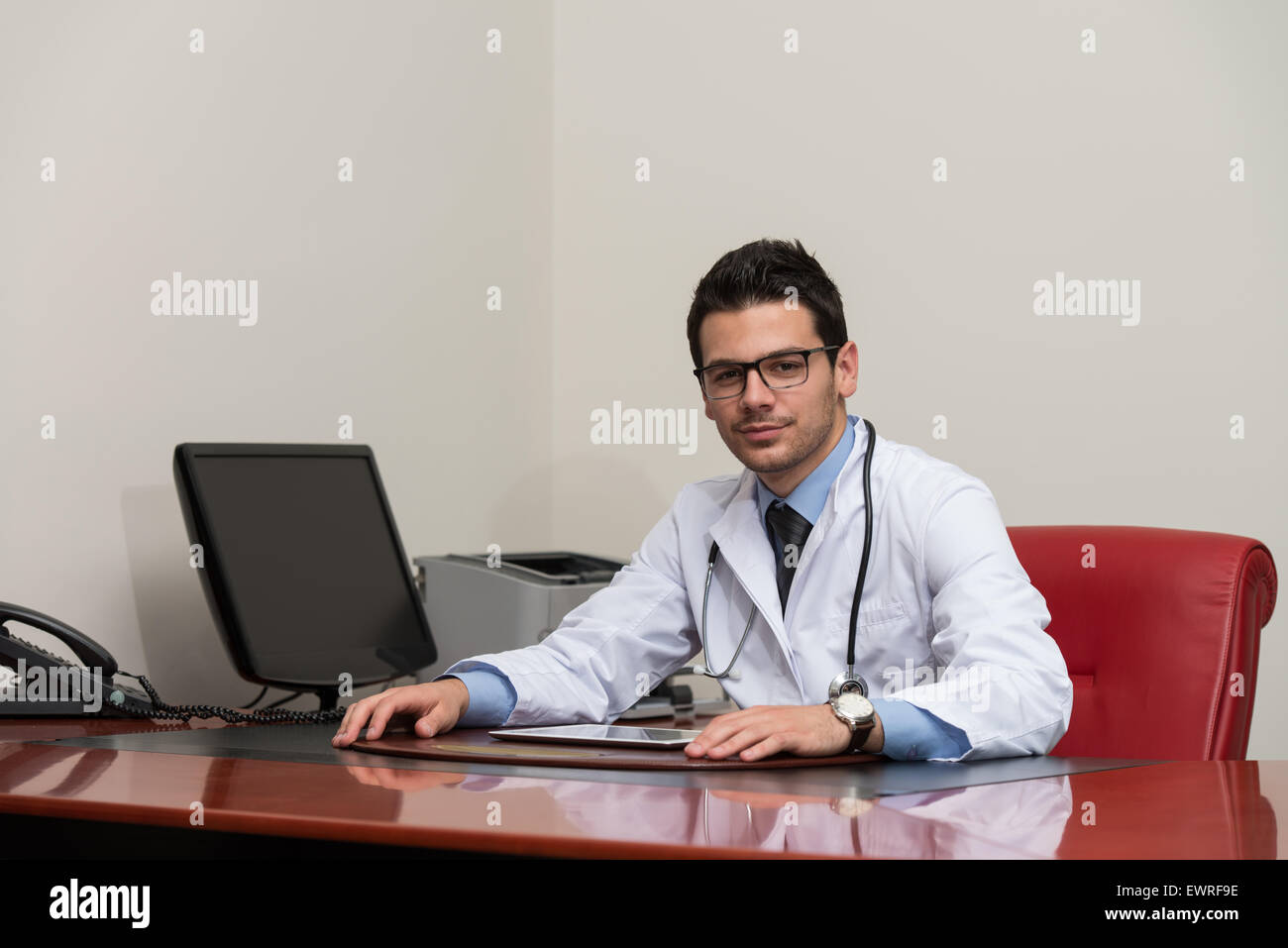 Handsome Doctor Looking At His Computer Monitor In His Office Stock ...