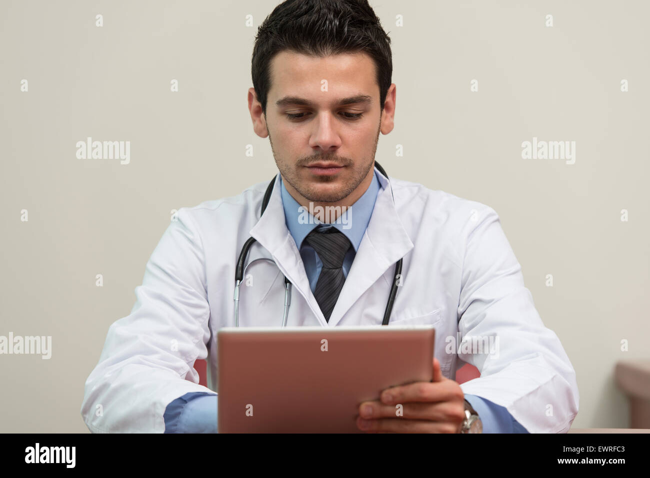 Handsome Doctor Looking At His Computer Monitor In His Office Stock ...