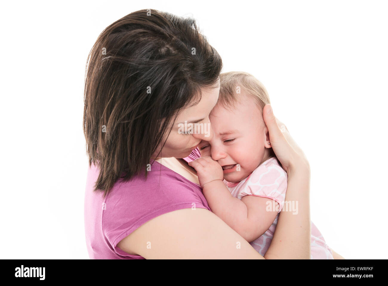Mother trying to calm her crying baby Stock Photo - Alamy