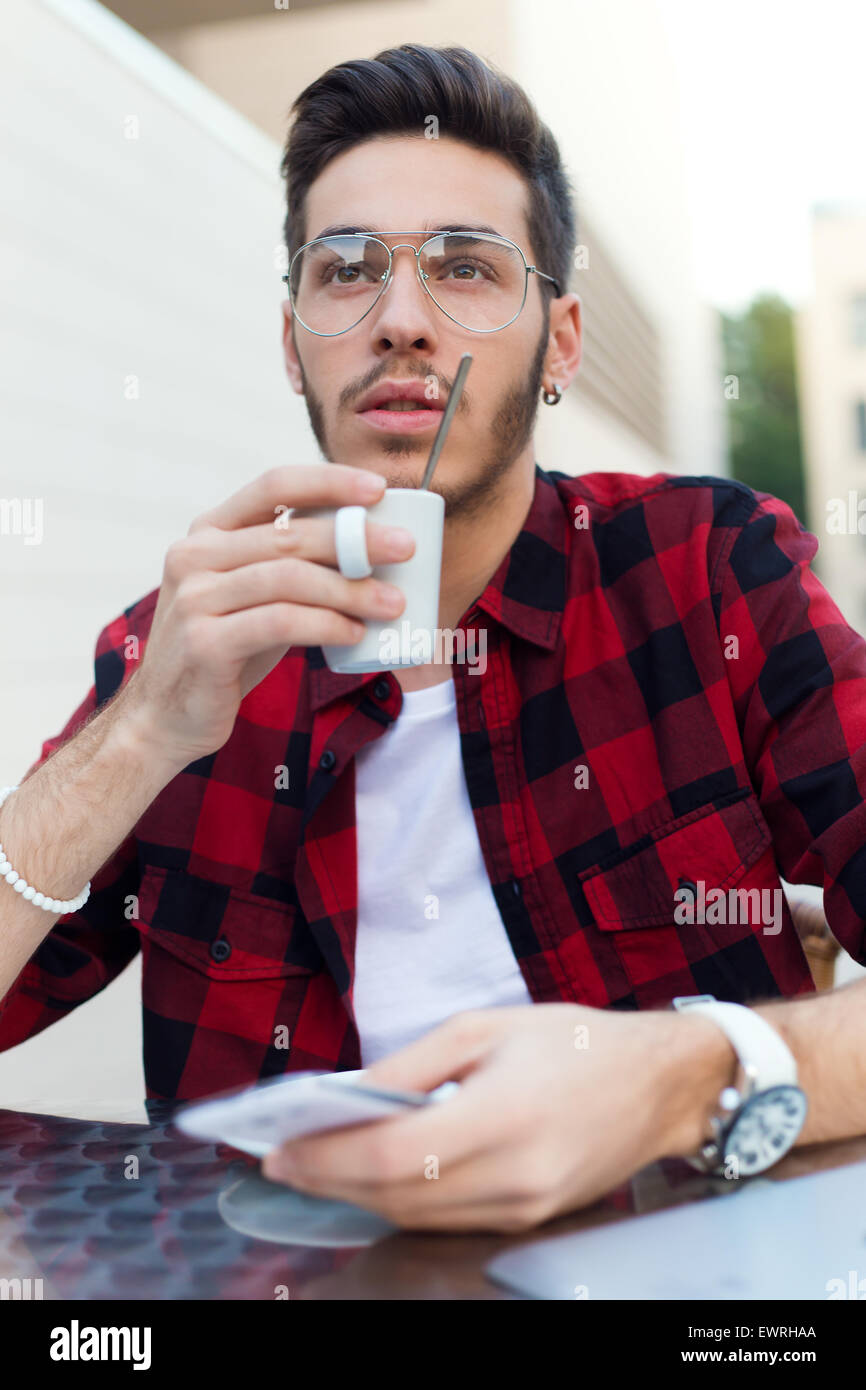 Outdoor portrait of confident entrepreneur drinking coffee focused in ...