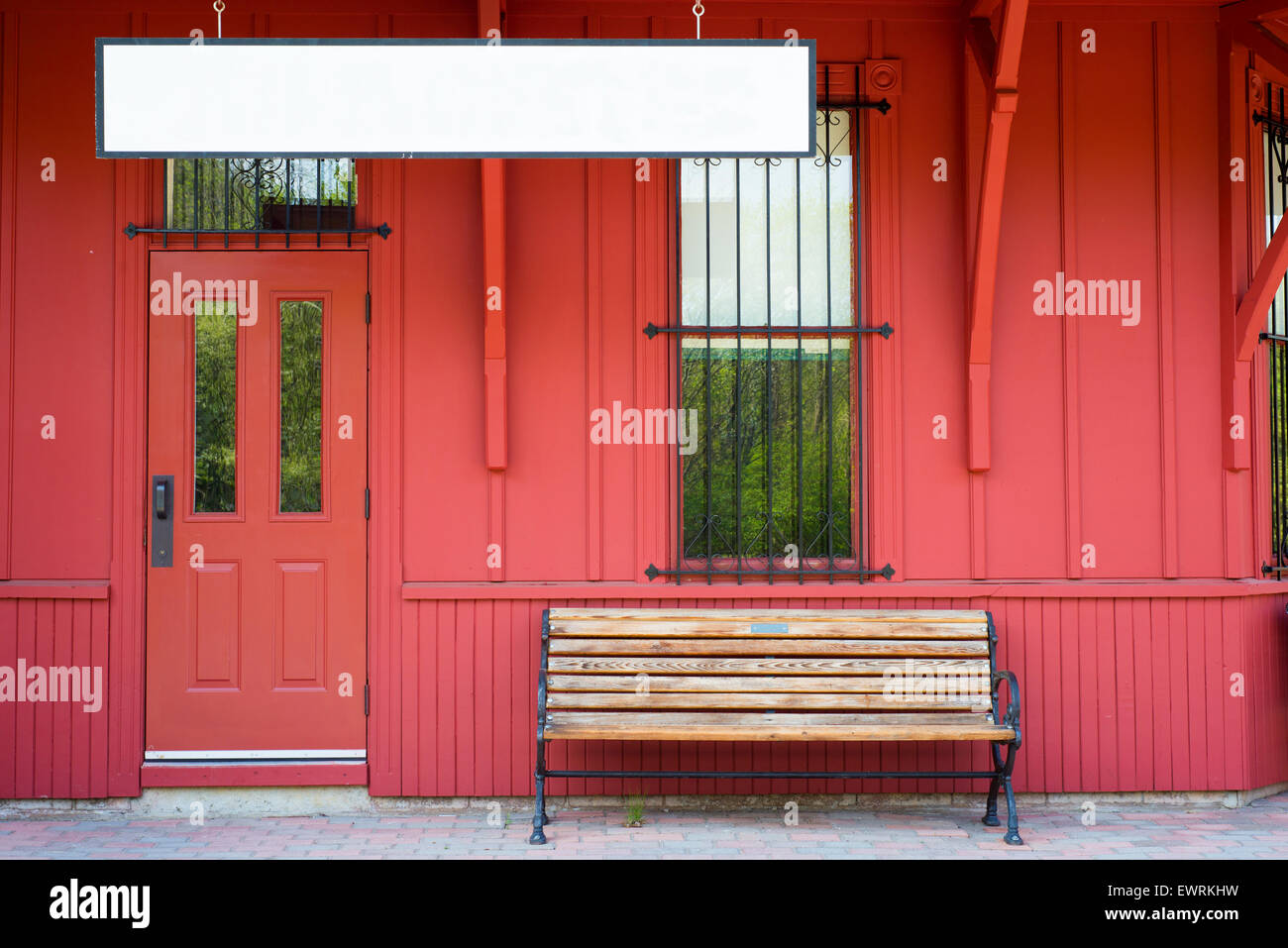 Empty bench by blank sign against red wooden walls Stock Photo - Alamy