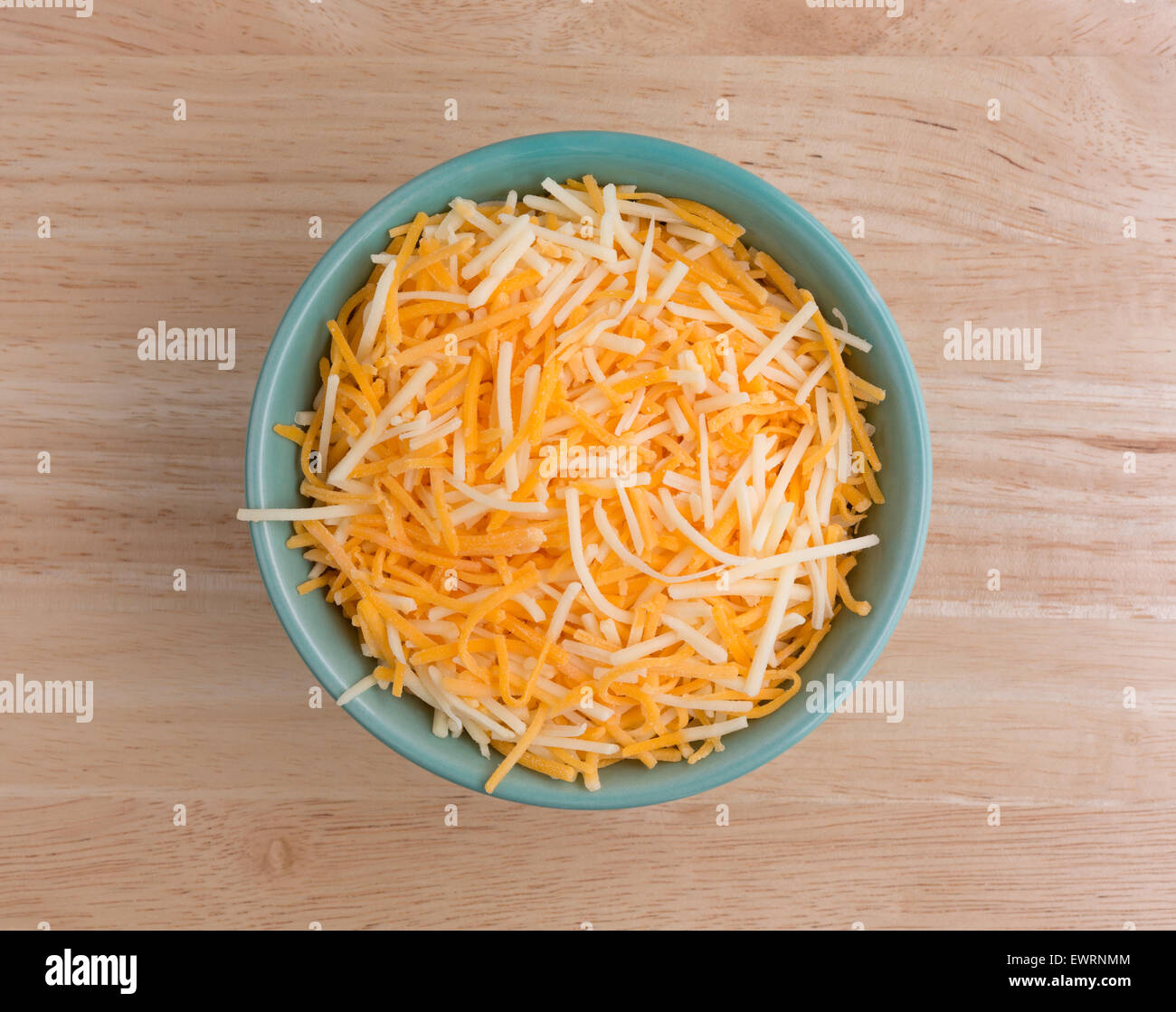 Top view of a small bowl filled with shredded white cheddar, sharp ...