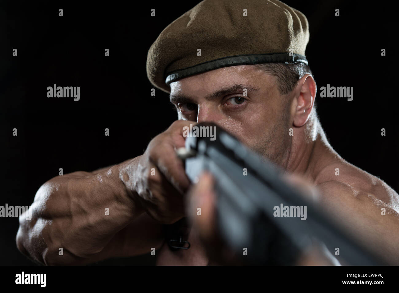 Action Hero Muscled Man Holding Machine Gun - Standing In Abandoned ...