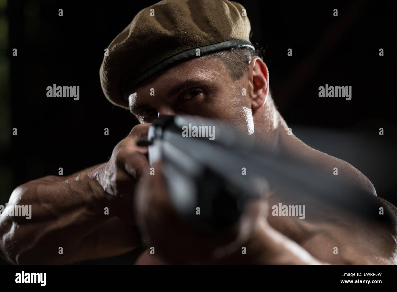 Action Hero Muscled Man Holding Machine Gun - Standing In Abandoned ...
