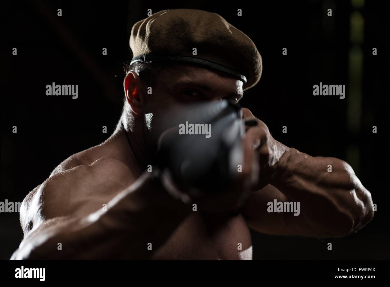 Action Hero Muscled Man Holding Machine Gun - Standing In Abandoned ...