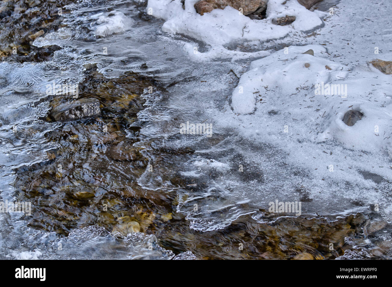 frozen mountain stream in the middle of ice, snow and rocks Stock Photo ...