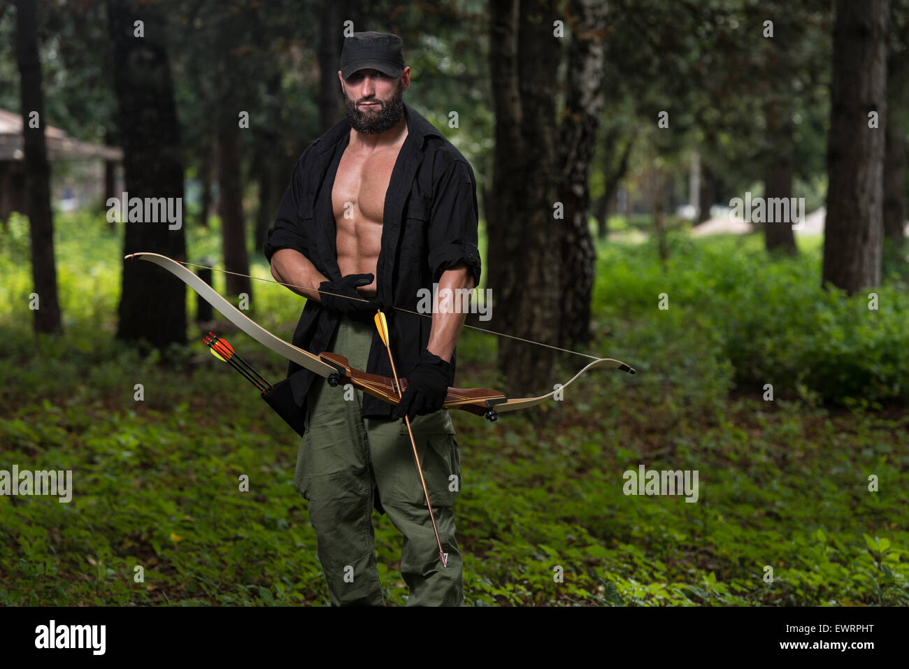 Beard Man With A Bow And Arrows In The Woods Stock Photo - Alamy