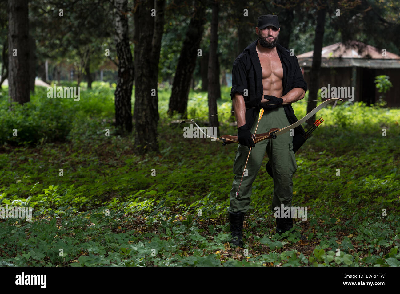 Beard Man With A Bow And Arrows In The Woods Stock Photo - Alamy