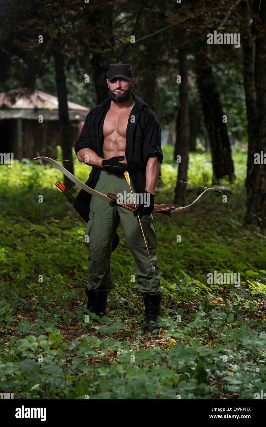 Beard Man With A Bow And Arrows In The Woods Stock Photo - Alamy