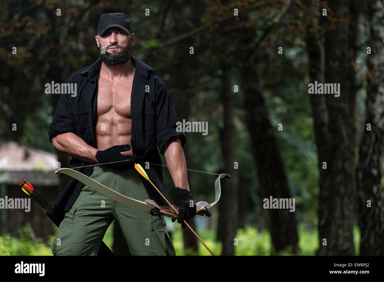 Beard Man With A Bow And Arrows In The Woods Stock Photo - Alamy