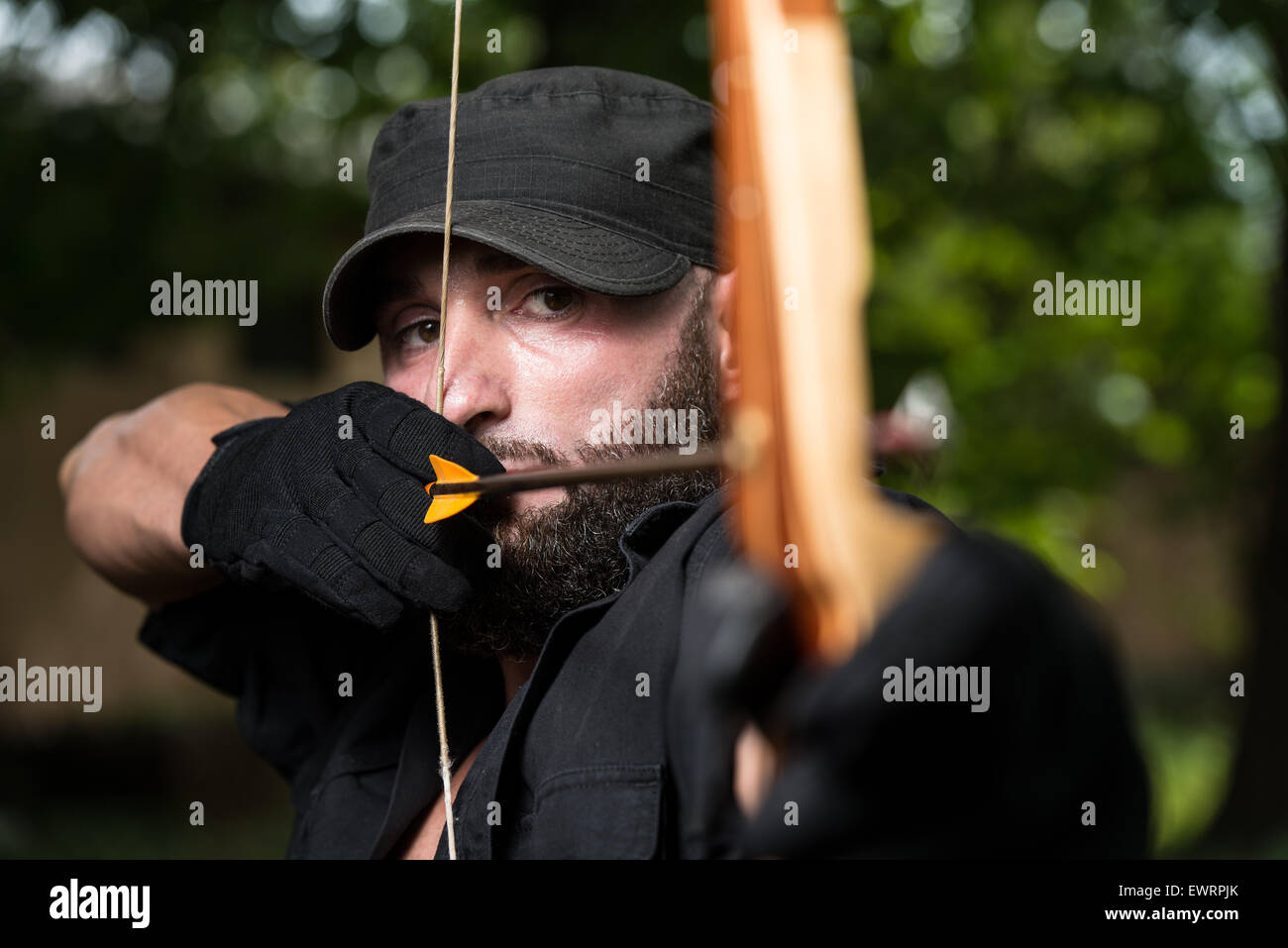 Beard Man With A Bow And Arrows In The Woods Stock Photo - Alamy