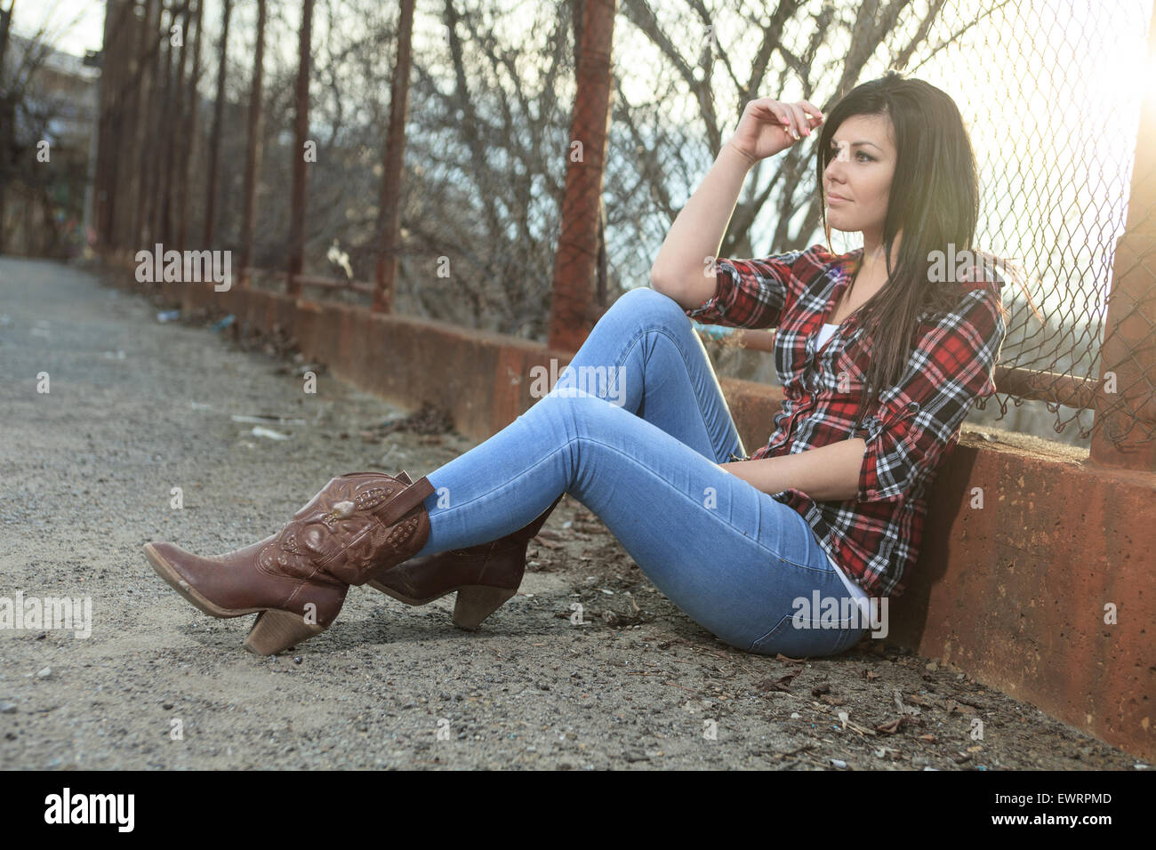 Woman sit on the ground Stock Photo - Alamy