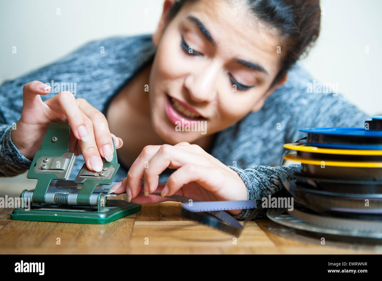 Young woman with 8 mm movie reel film and editing machine Stock Photo ...