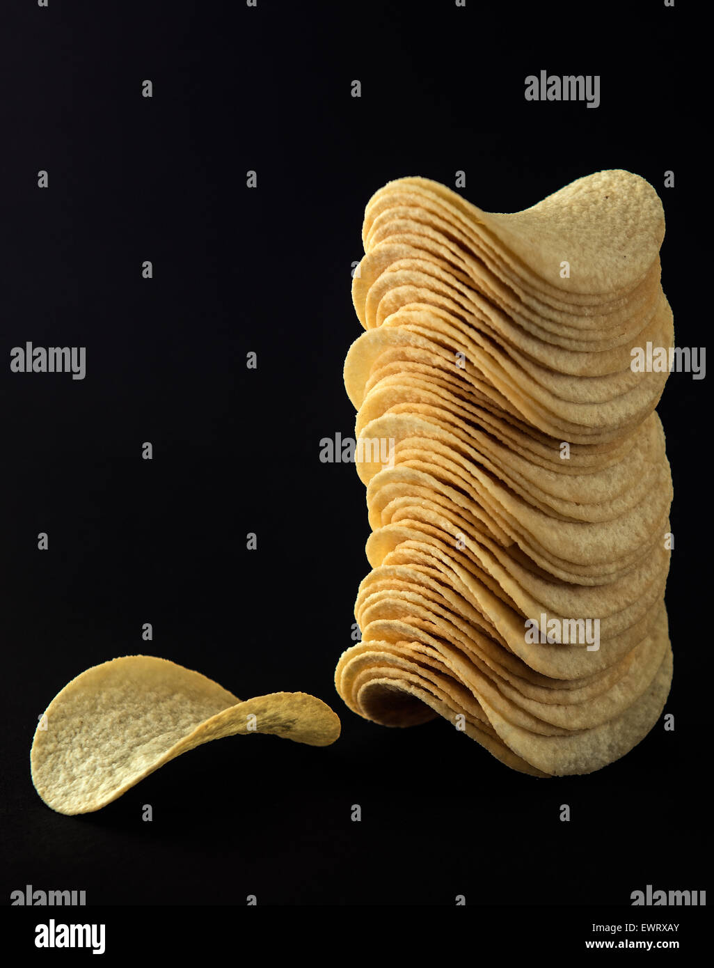 Pringles crisps pile or Crispy potato chips on black background as ...